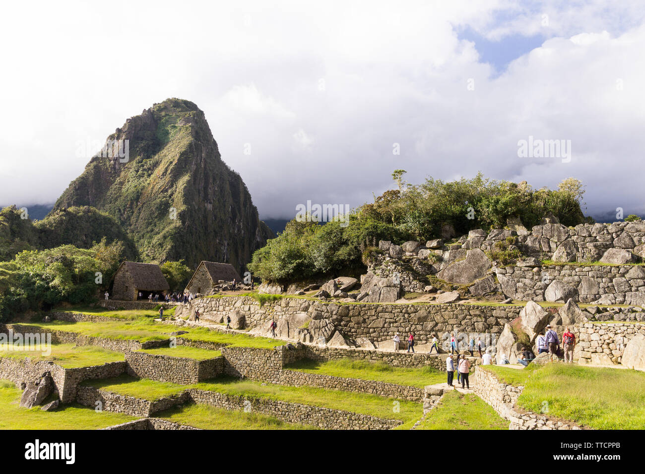 Machu Picchu Peru - Tourists walking around the Machu Picchu citadel ...