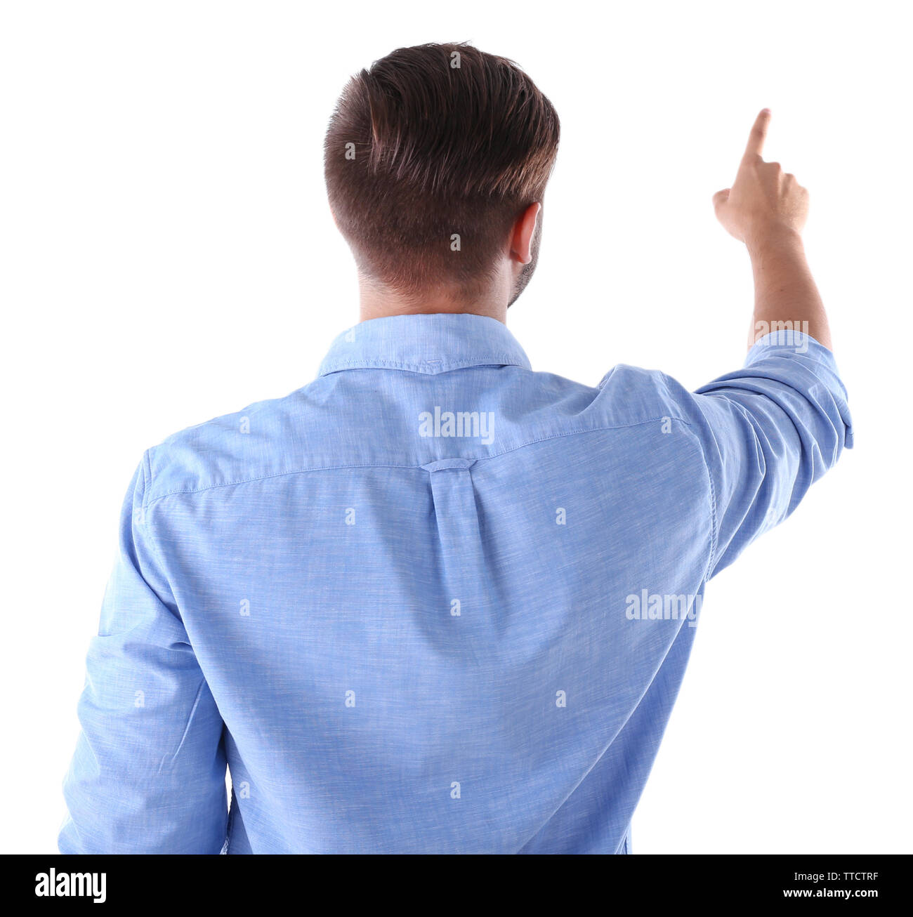 Back view of Caucasian young man in a blue shirt pointing, isolated on ...