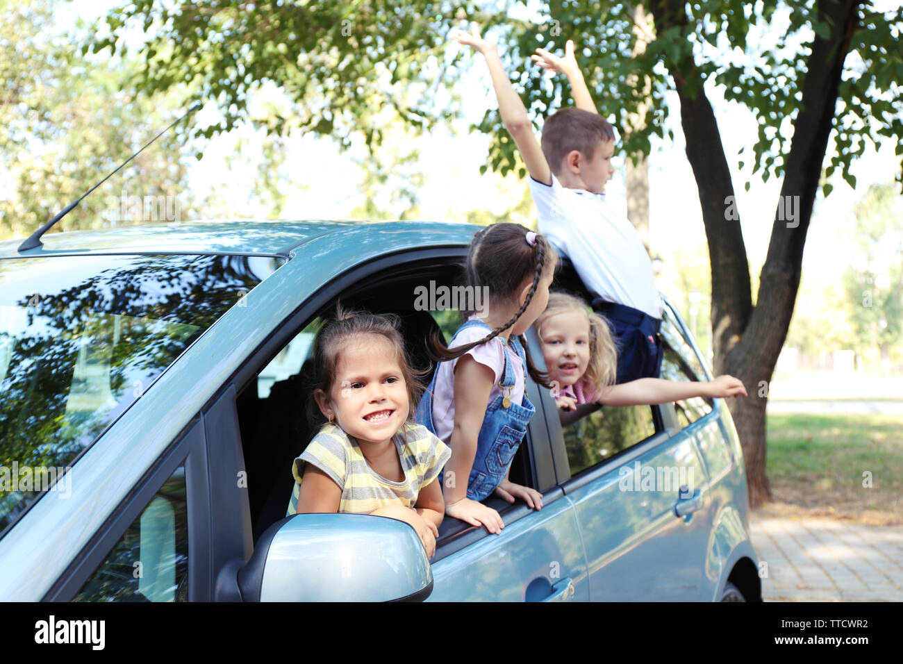 Smiling children in the car Stock Photo - Alamy