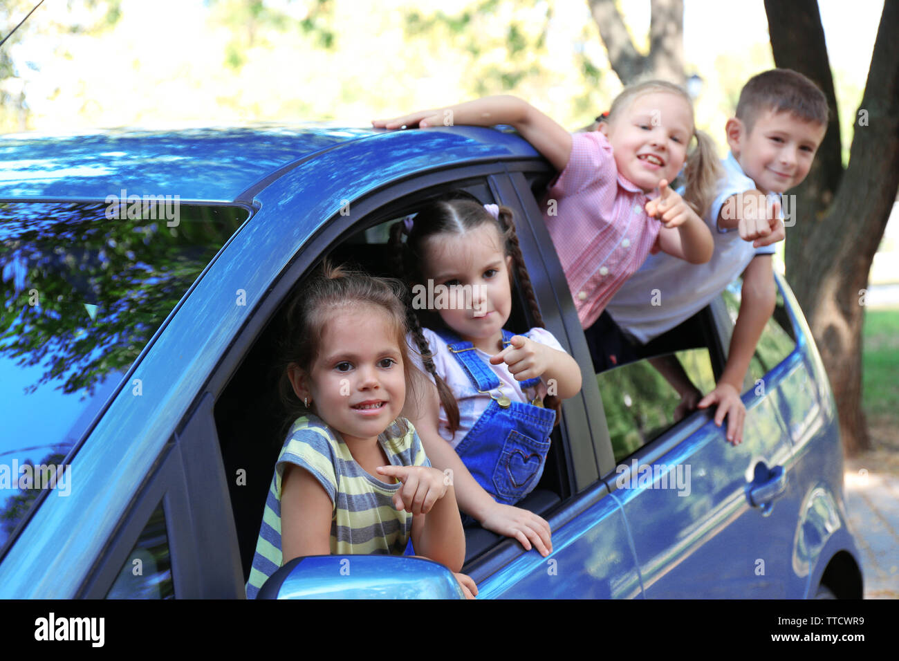 Smiling children in the car Stock Photo - Alamy