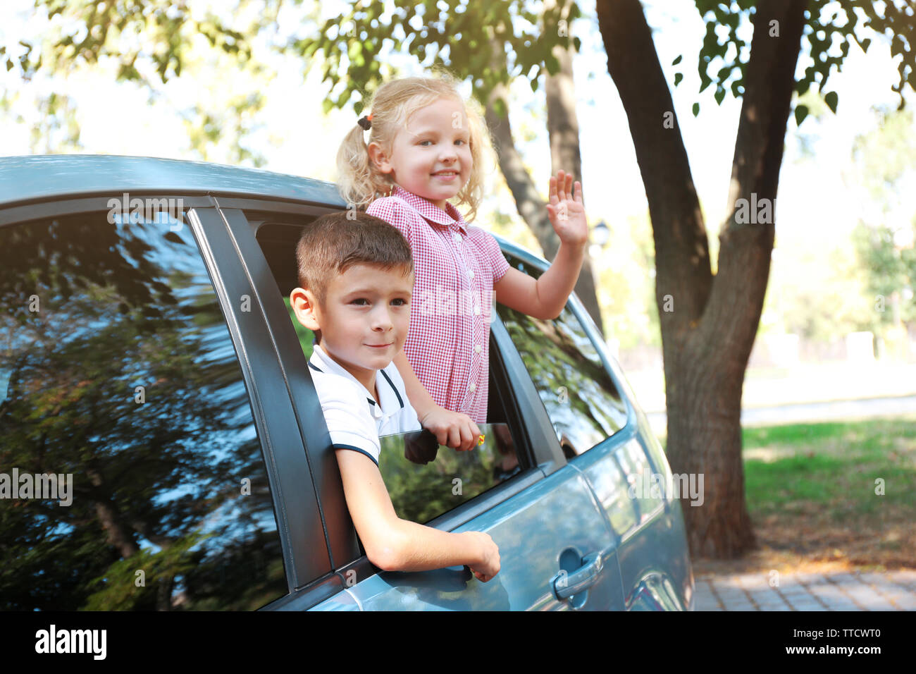 Smiling children in the car Stock Photo - Alamy