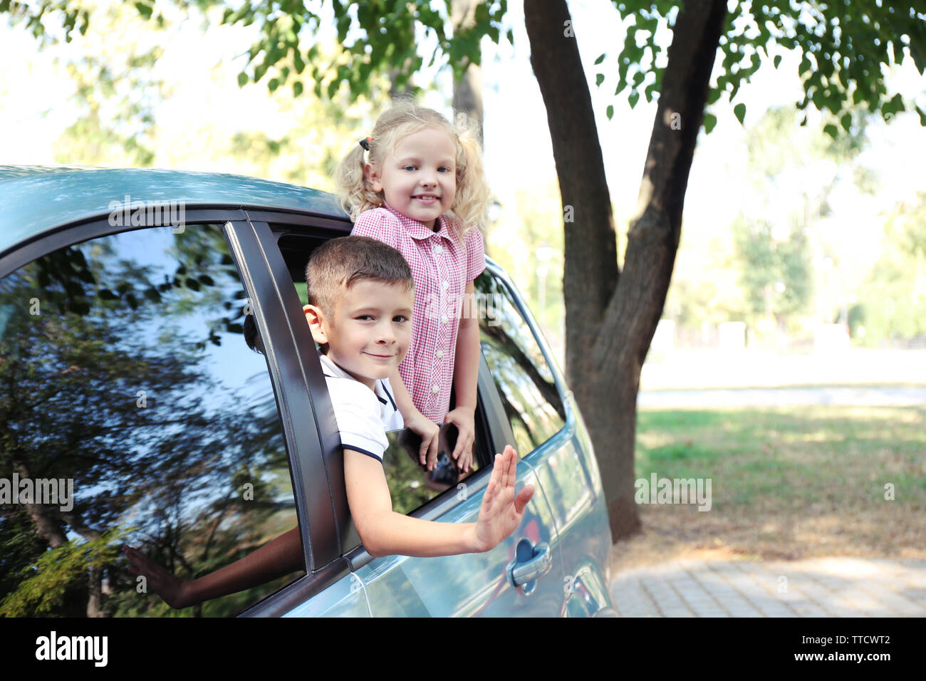 Smiling children in the car Stock Photo - Alamy