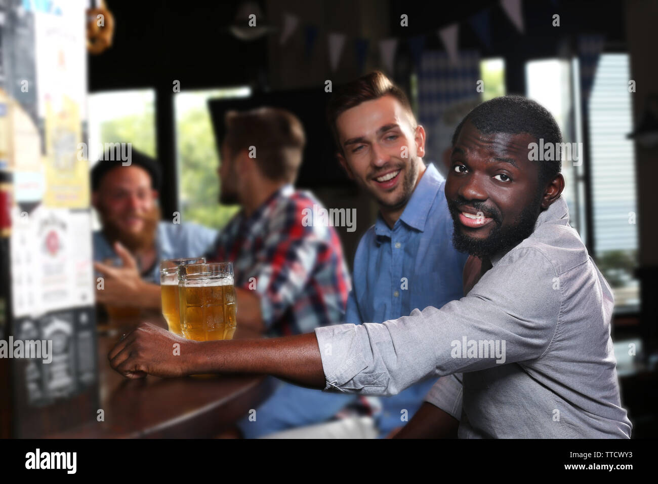Men drinking beer in pub hi-res stock photography and images - Alamy