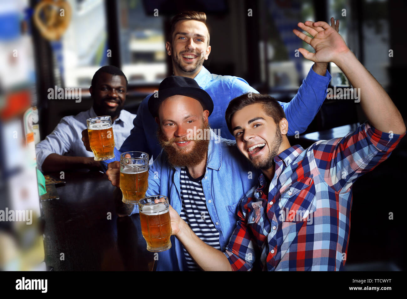 Young men drinking beer in pub Stock Photo - Alamy