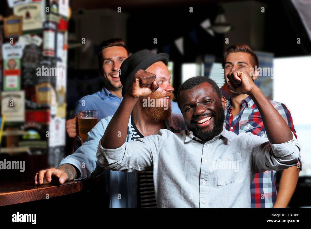 Young men drinking beer in pub Stock Photo - Alamy