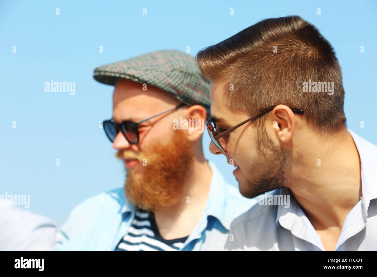 Two young men talking on the riverside Stock Photo - Alamy