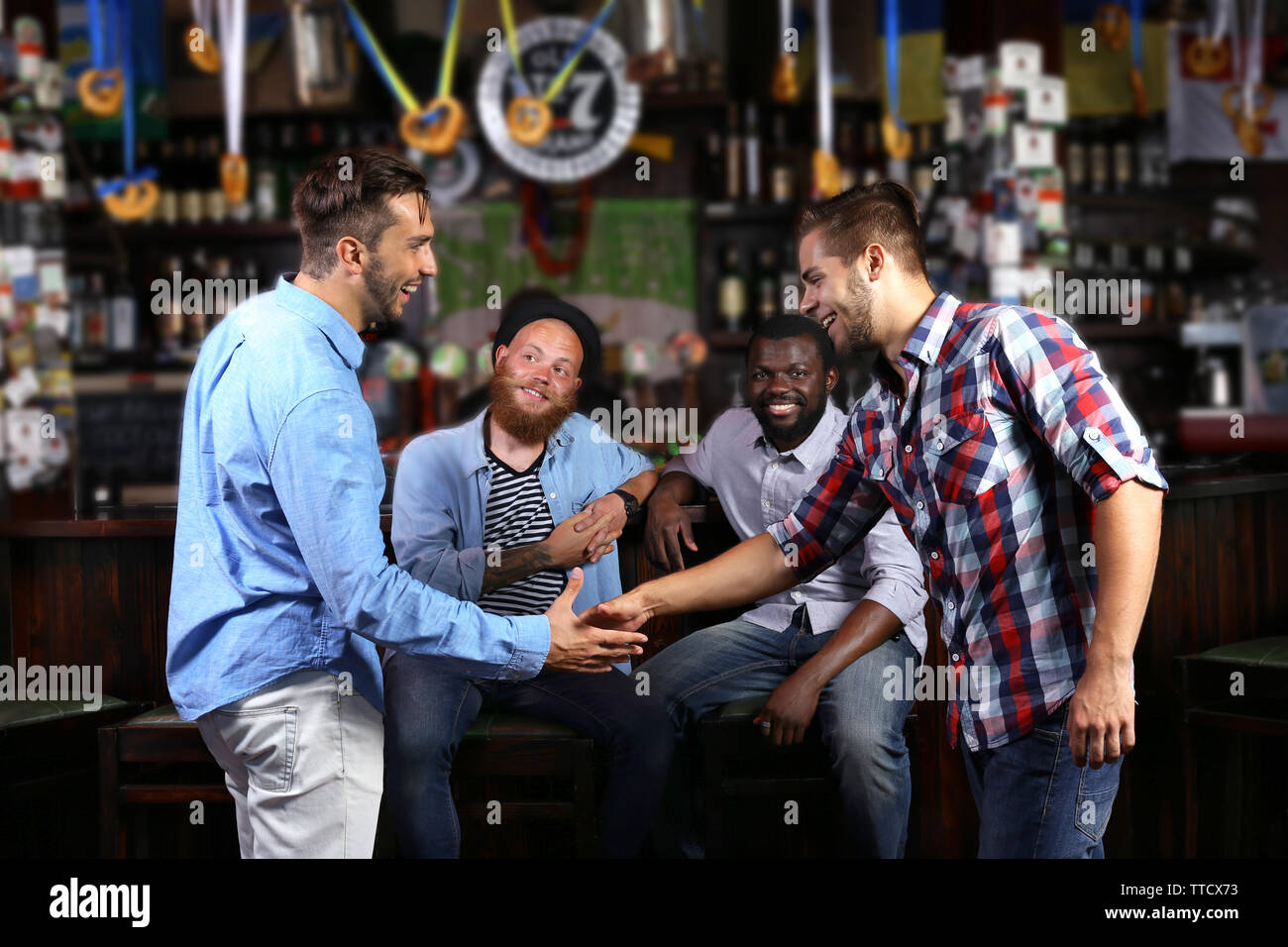 Young people having fun in a bar Stock Photo - Alamy