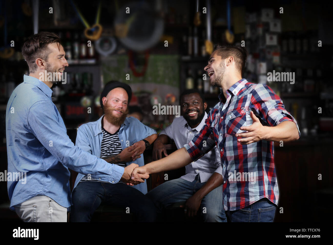 Young people having fun in a bar Stock Photo - Alamy
