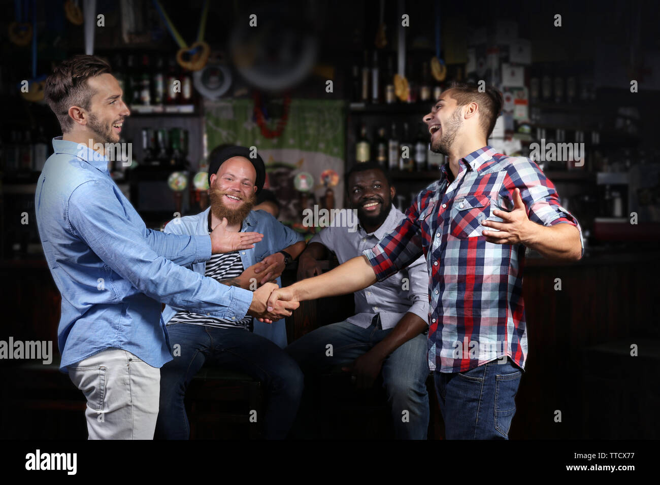 Young people having fun in a bar Stock Photo - Alamy