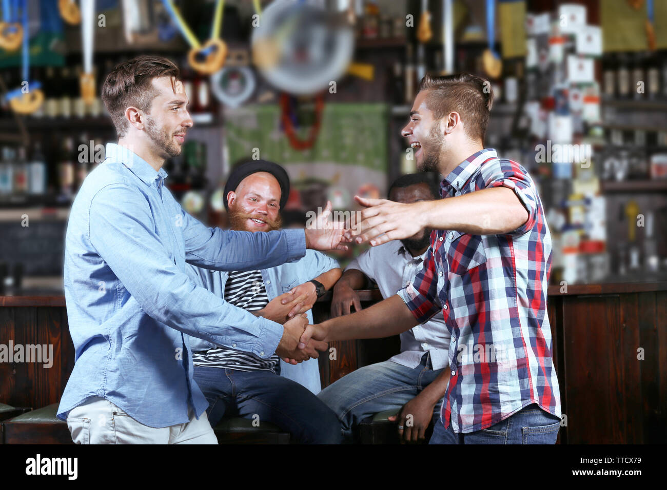 Young people having fun in a bar Stock Photo - Alamy
