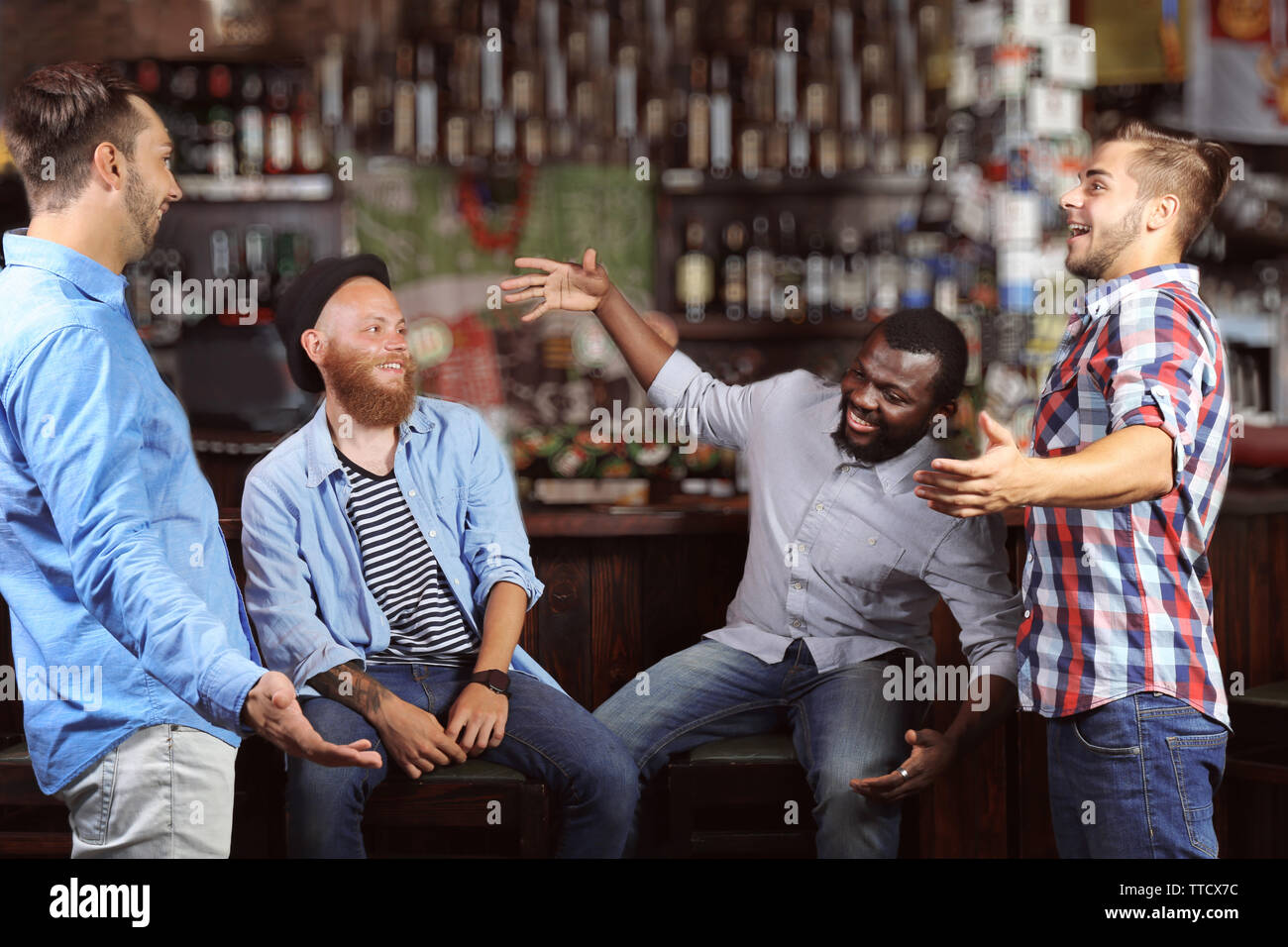 Young people having fun in a bar Stock Photo - Alamy