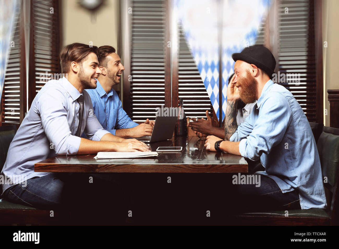 Young men talking in cafe Stock Photo - Alamy