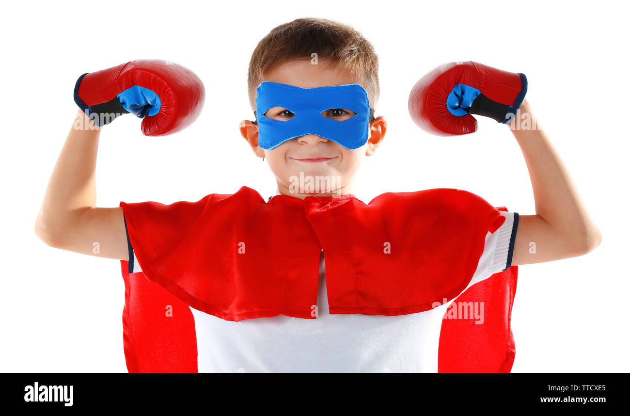 Boy dressed as superhero with boxing gloves poses in studio isolated on ...