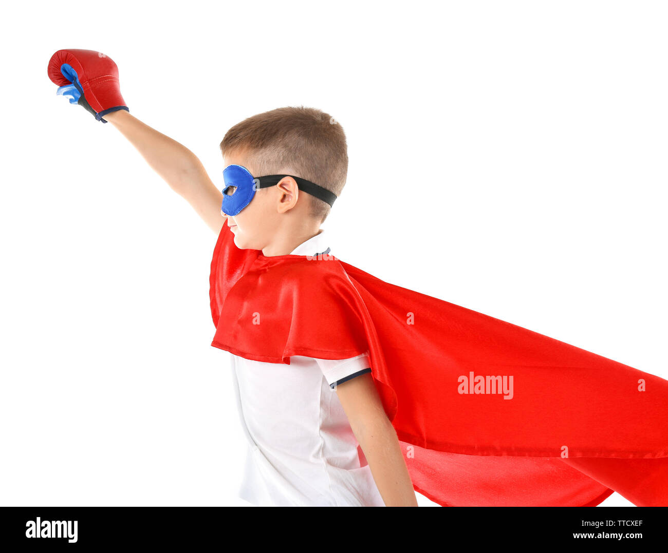 Boy dressed as superhero with boxing gloves poses in studio isolated on ...