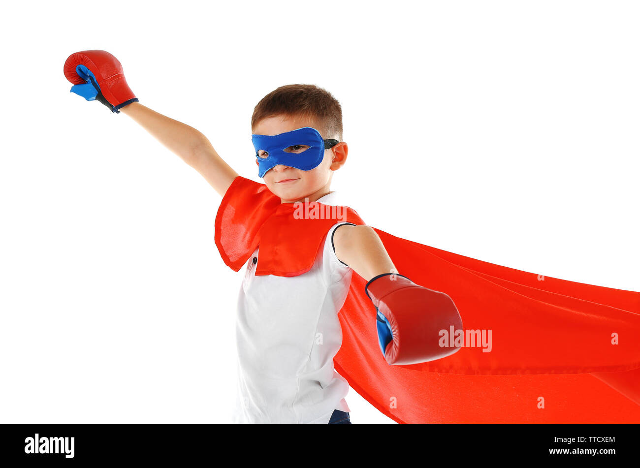 Boy dressed as superhero with boxing gloves poses in studio isolated on ...