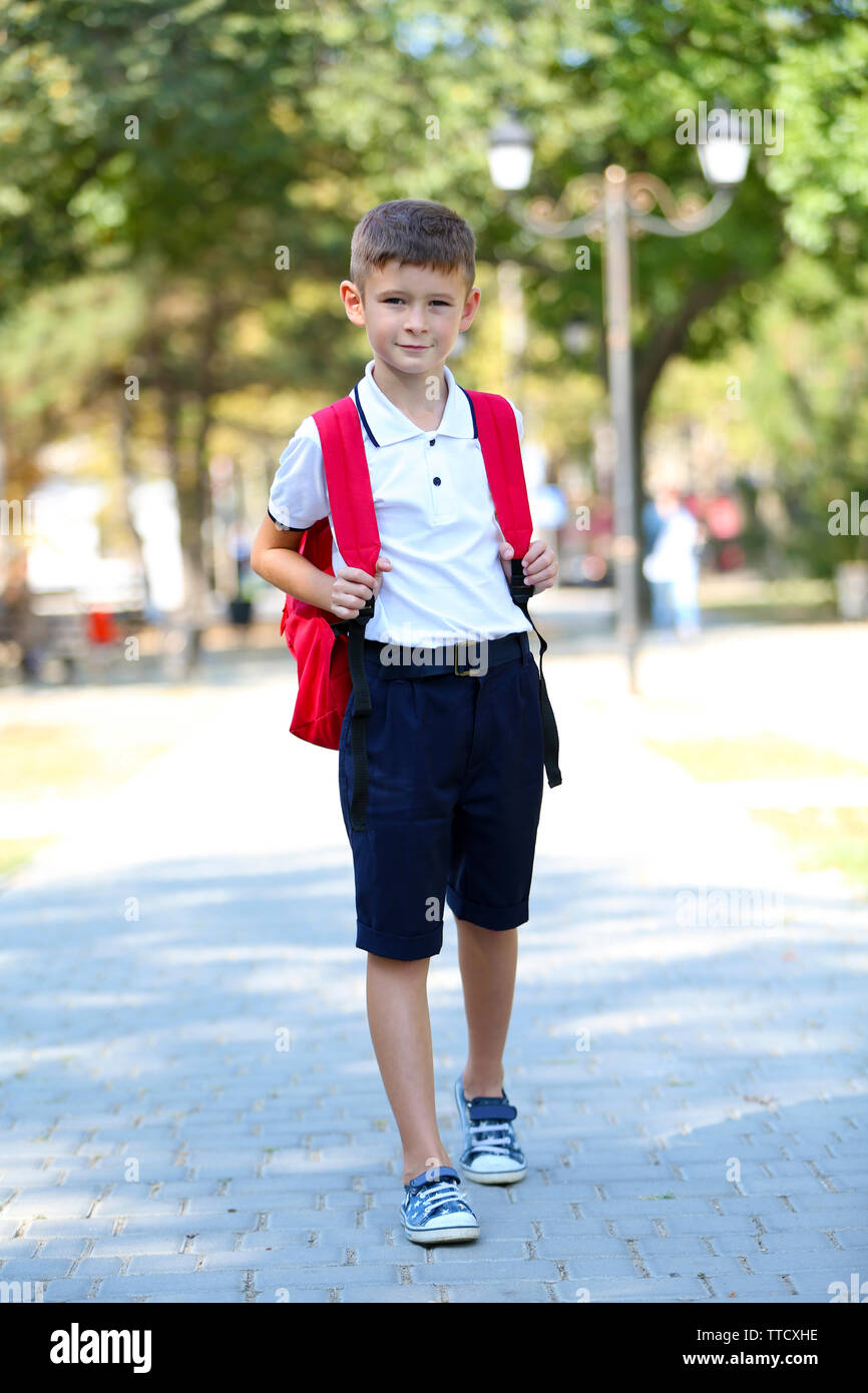 Little boy with large school bag, outdoor Stock Photo - Alamy