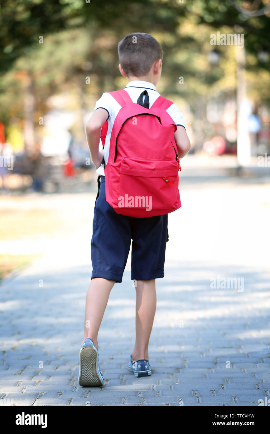 Little boy with large school bag, outdoor Stock Photo - Alamy