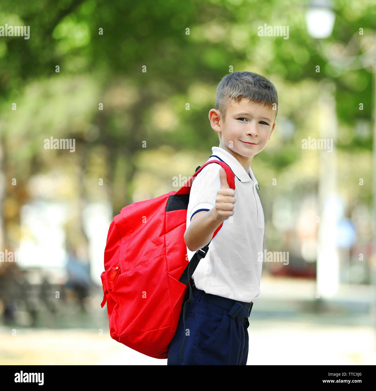 Little boy with large school bag, outdoor Stock Photo - Alamy