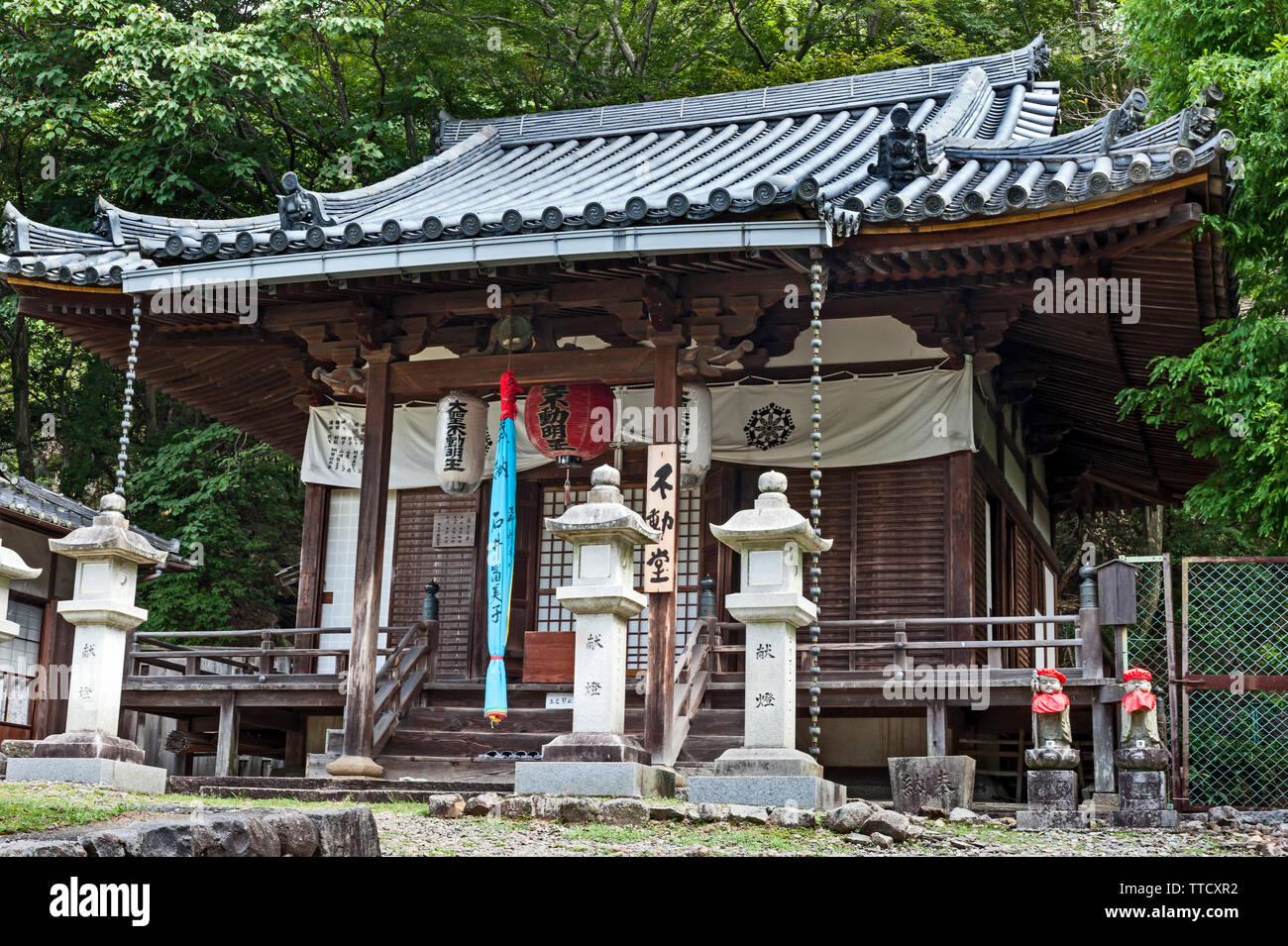 Small Buddhist shrine in Nara Park Japan with three stone lanterns and ...