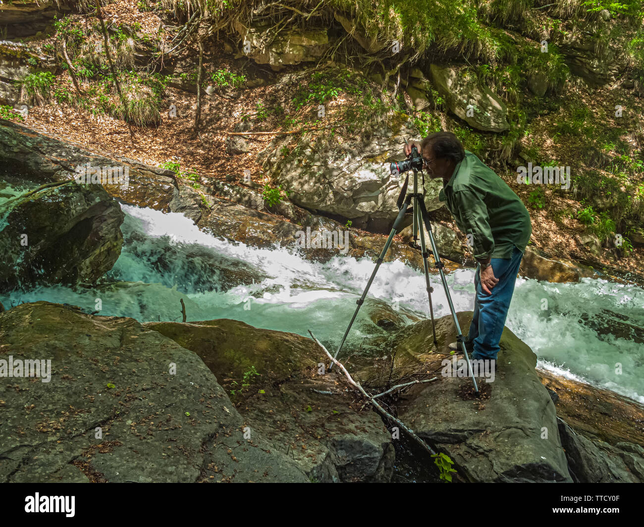 landscape photographer taking pictures in the stream bed Stock Photo ...
