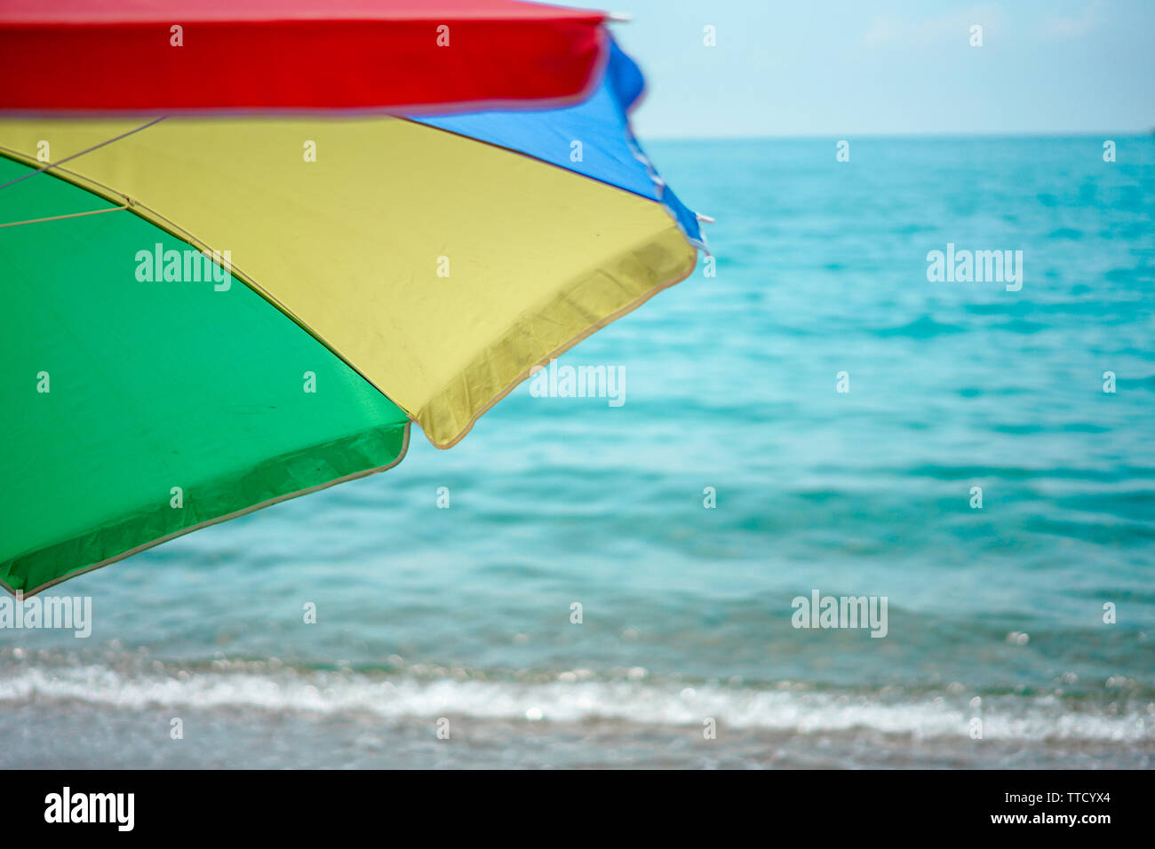 colorful beach umbrella against the sun light Stock Photo - Alamy