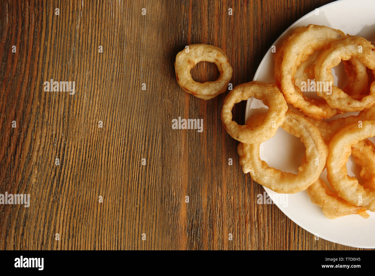 Chips rings on plate on wooden background Stock Photo - Alamy