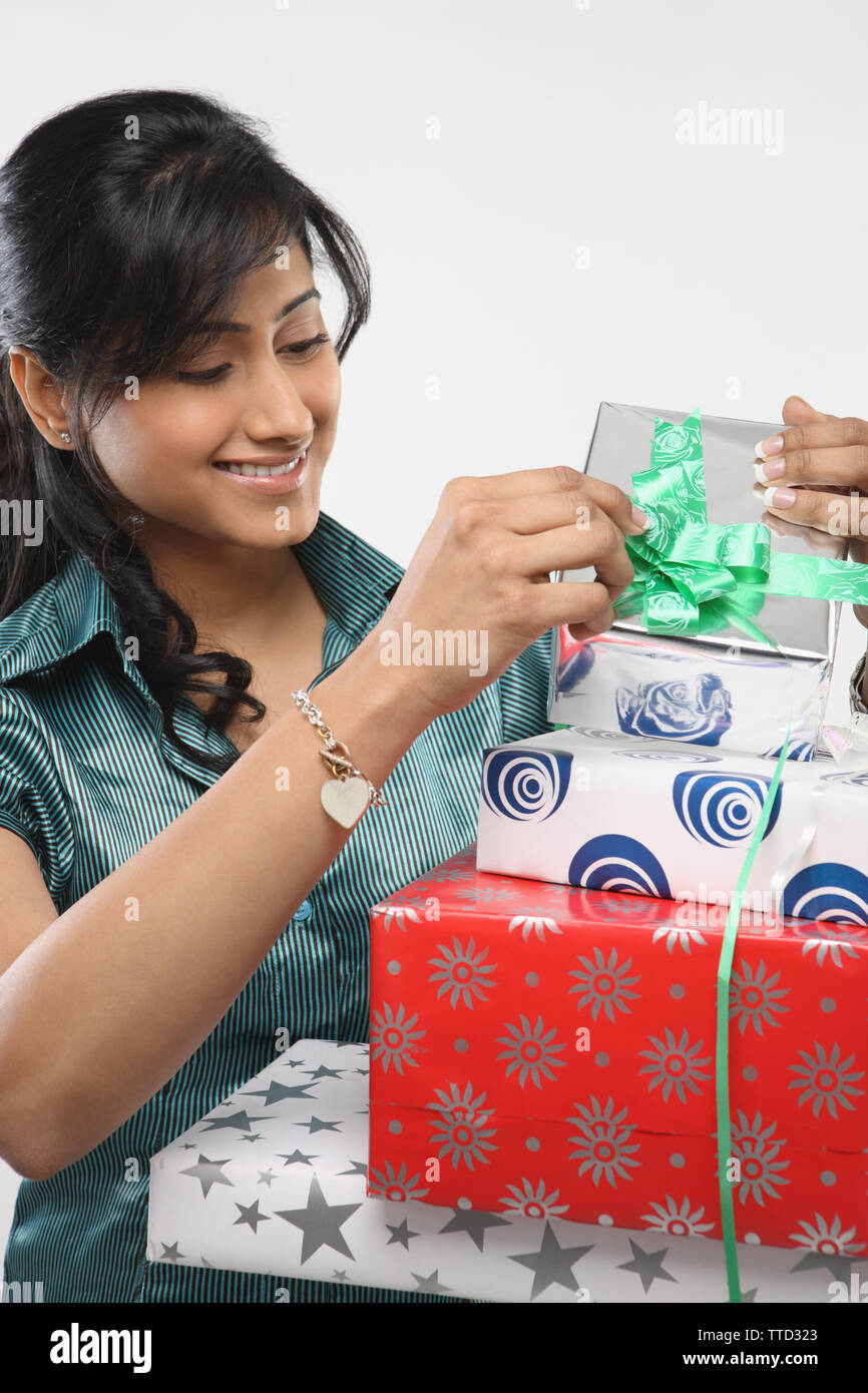 Woman opening a gift box and smiling Stock Photo - Alamy