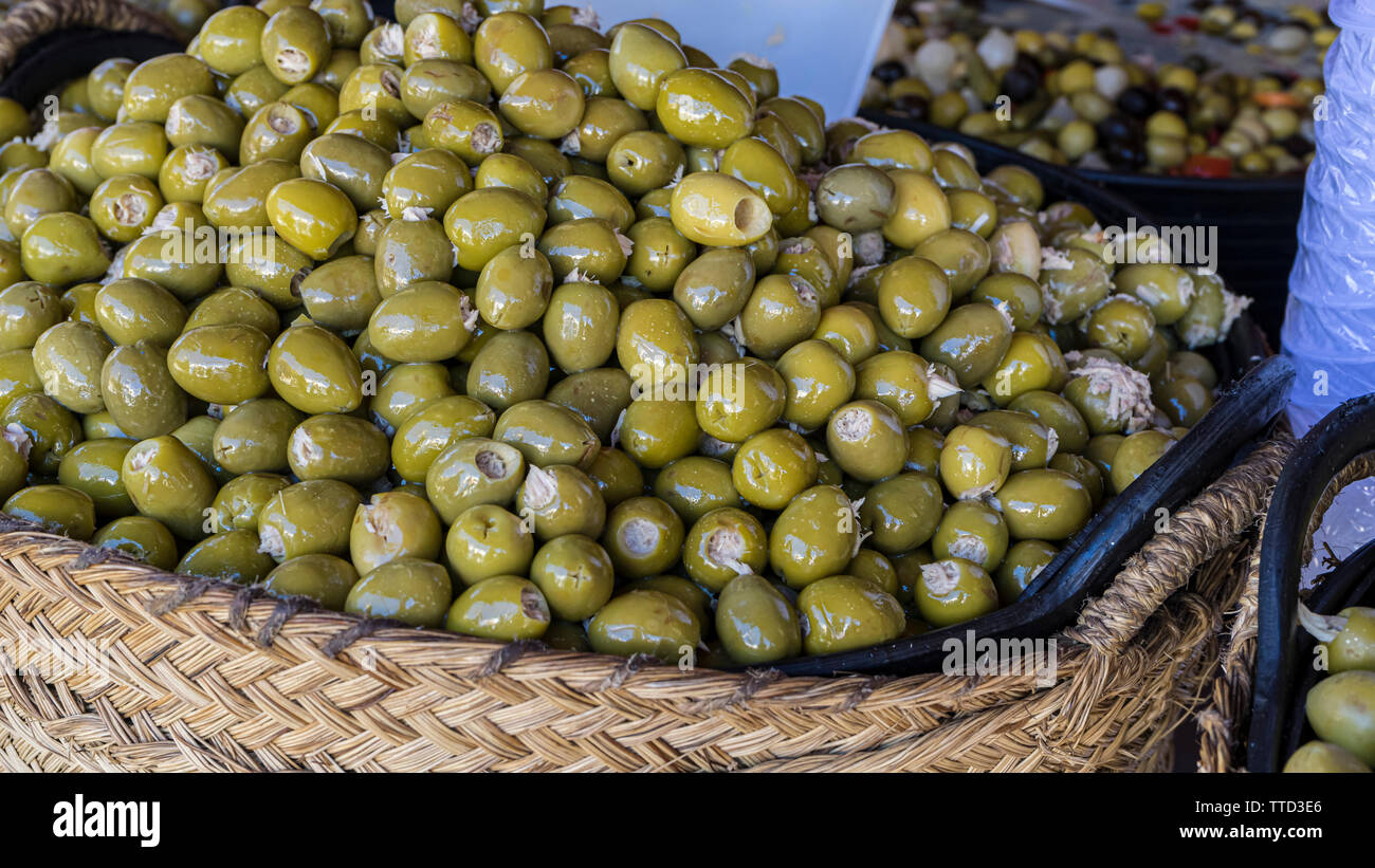 Olives stuffed with anchovy, typical Spanish food, pickles in vinegar ...