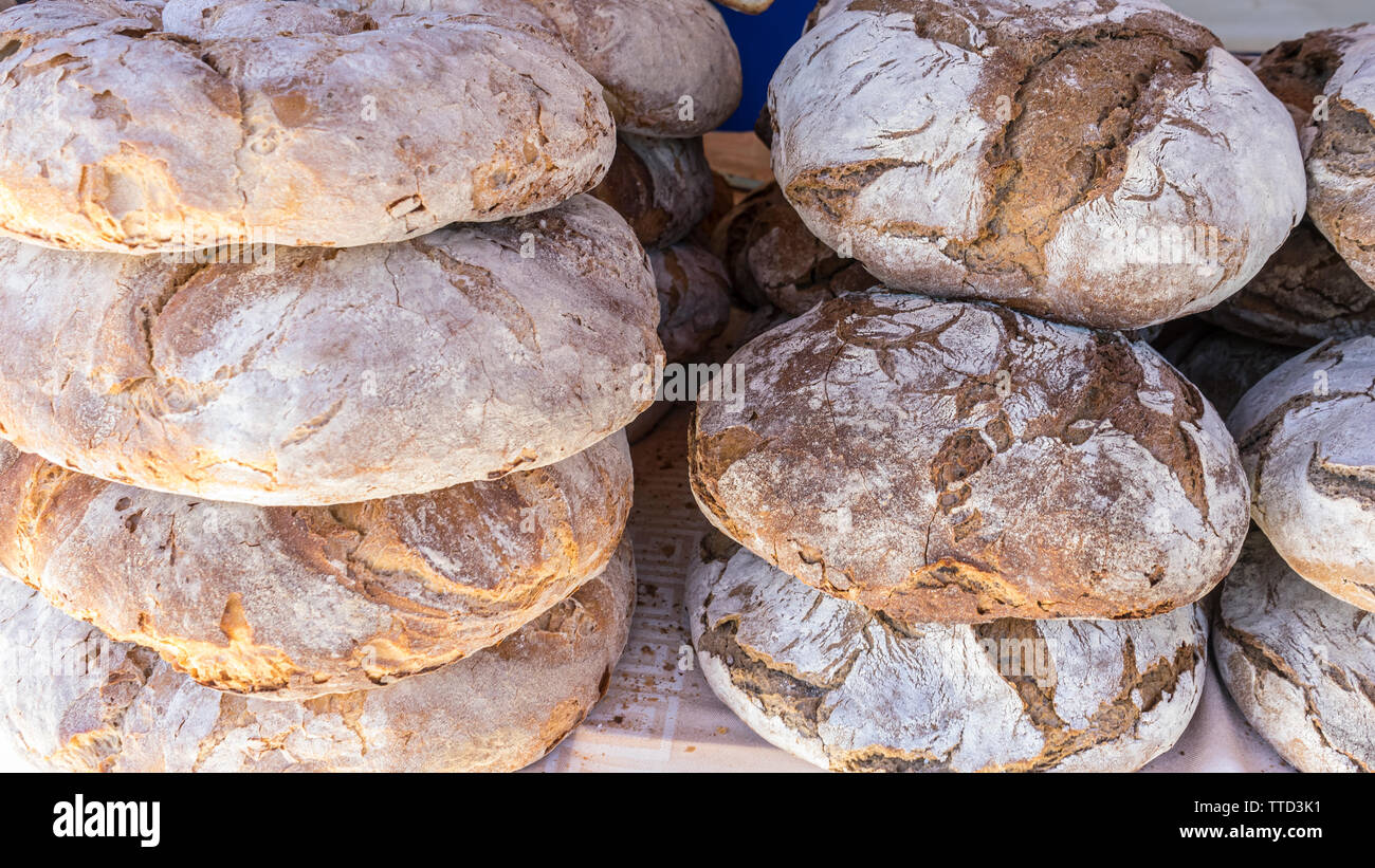 Artisan bread. Table with loaves of bread made by hand at a medieval ...
