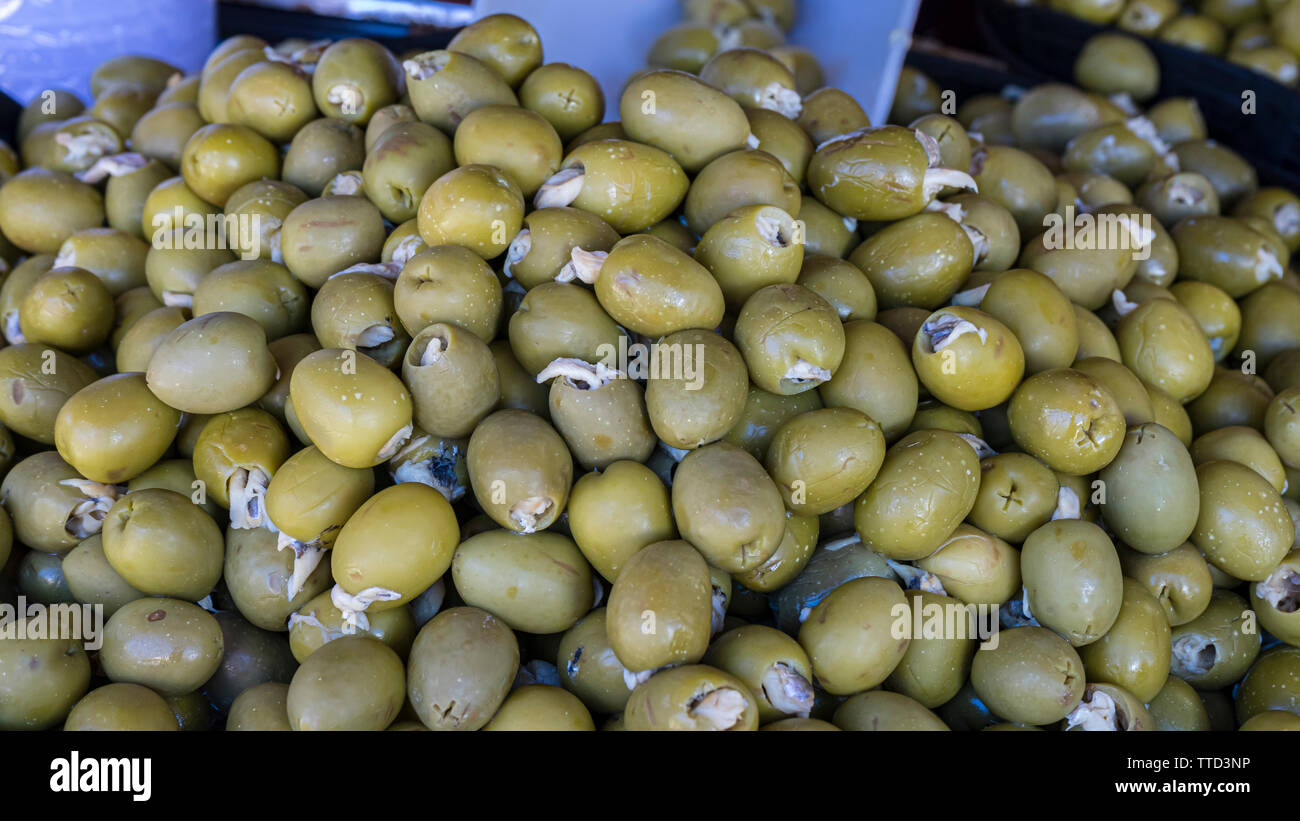 Olives stuffed with anchovy, typical Spanish food, pickles in vinegar ...