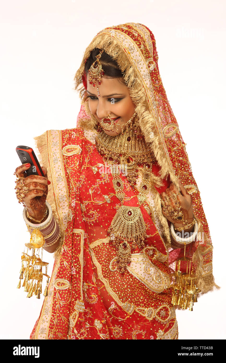 Indian bride using a mobile phone Stock Photo - Alamy