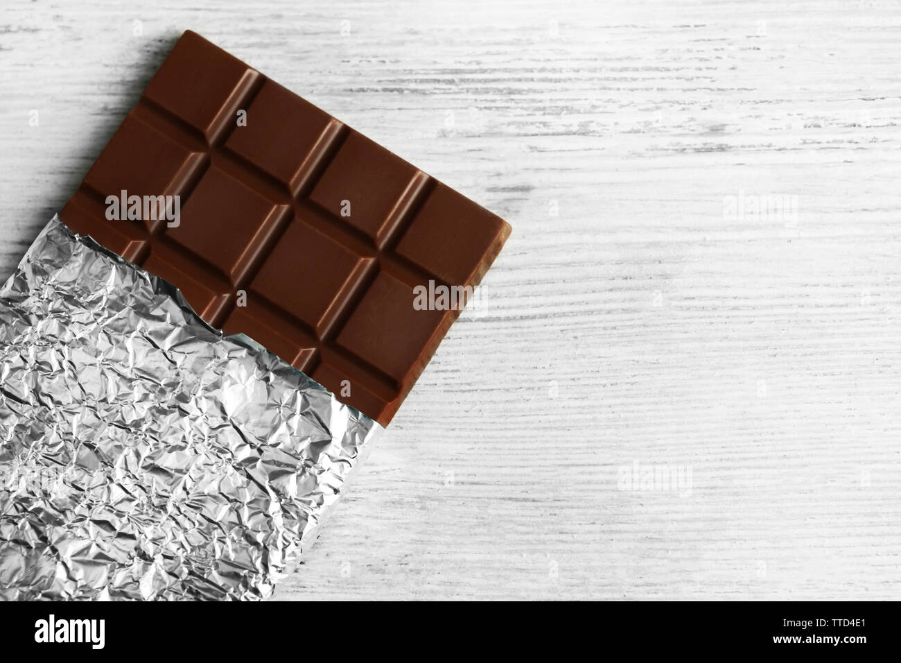 Dark Chocolate bar in foil on gray background Stock Photo - Alamy