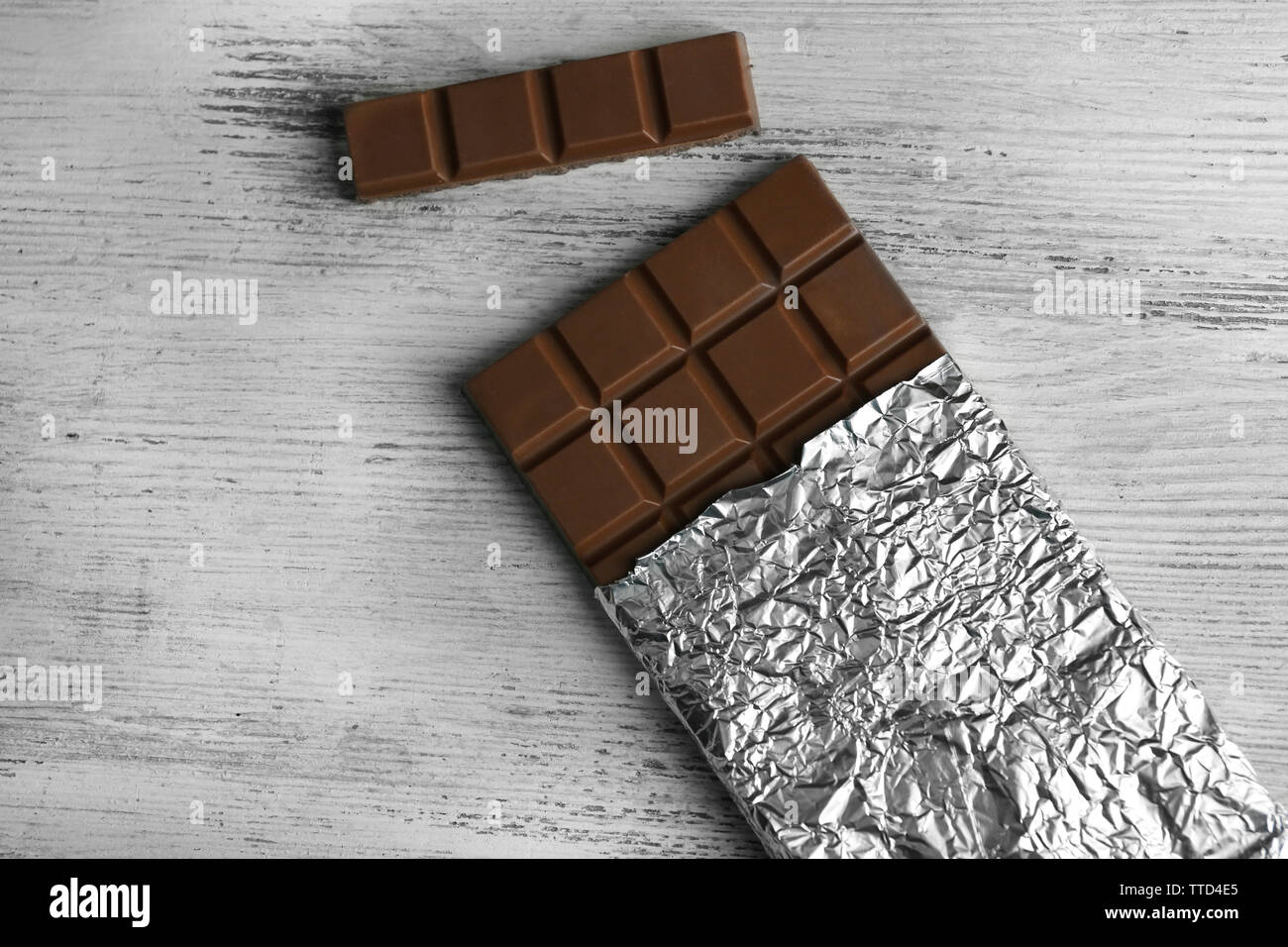 Dark Chocolate bar in foil on gray background Stock Photo - Alamy