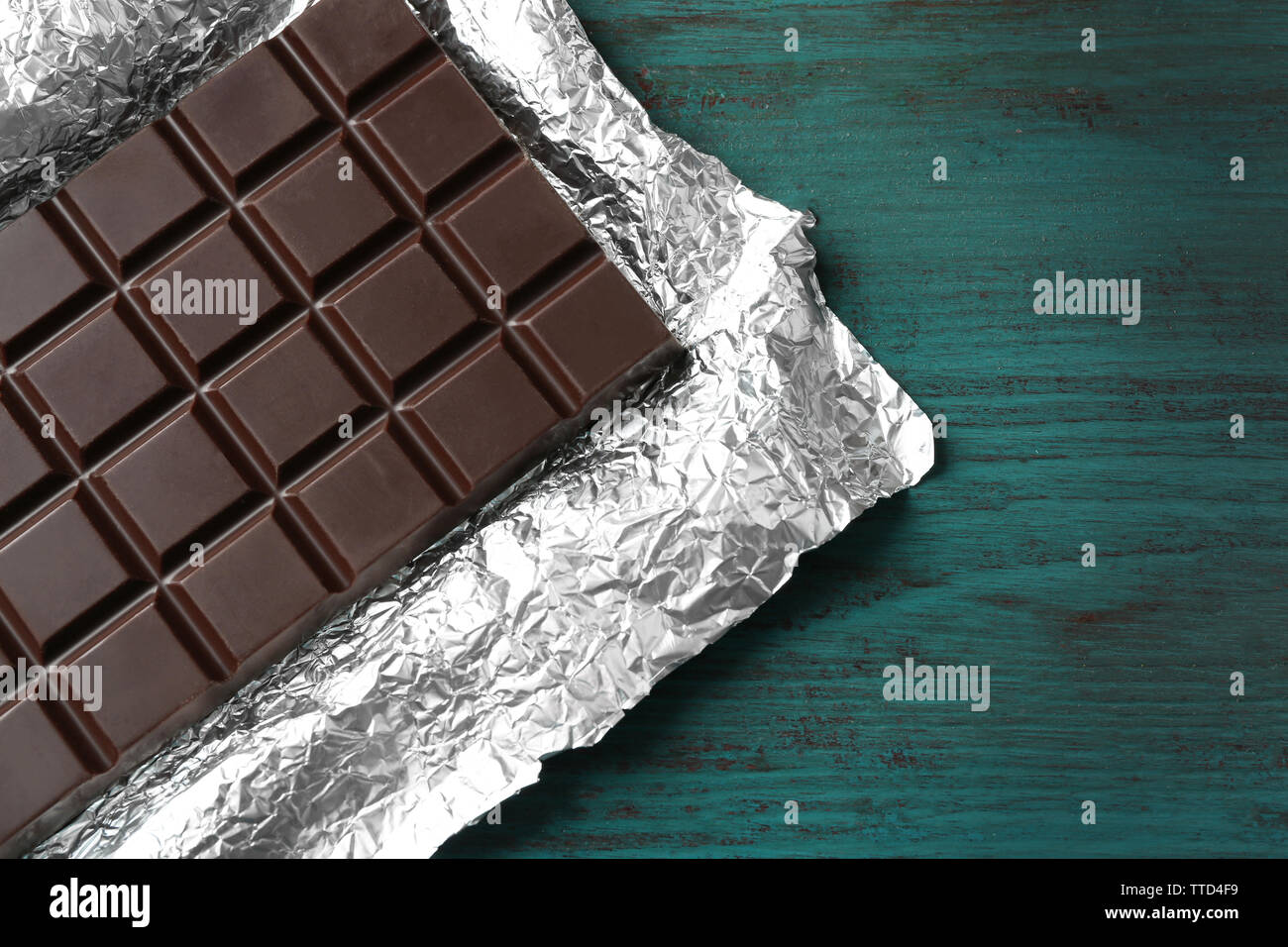 Dark Chocolate bar in foil on gray background Stock Photo - Alamy