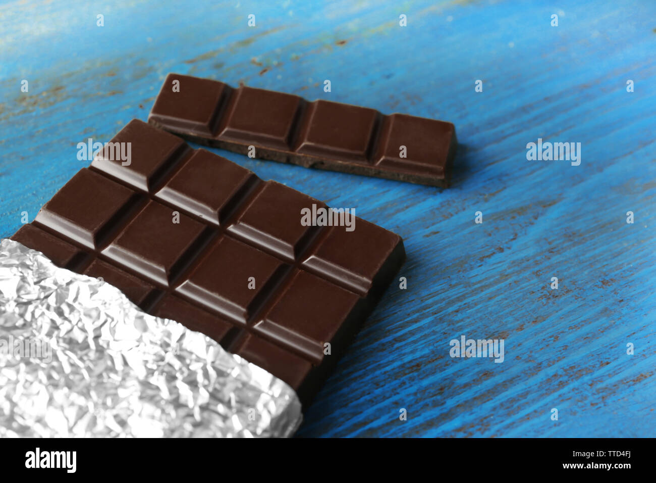Dark Chocolate bar in foil on gray background Stock Photo - Alamy