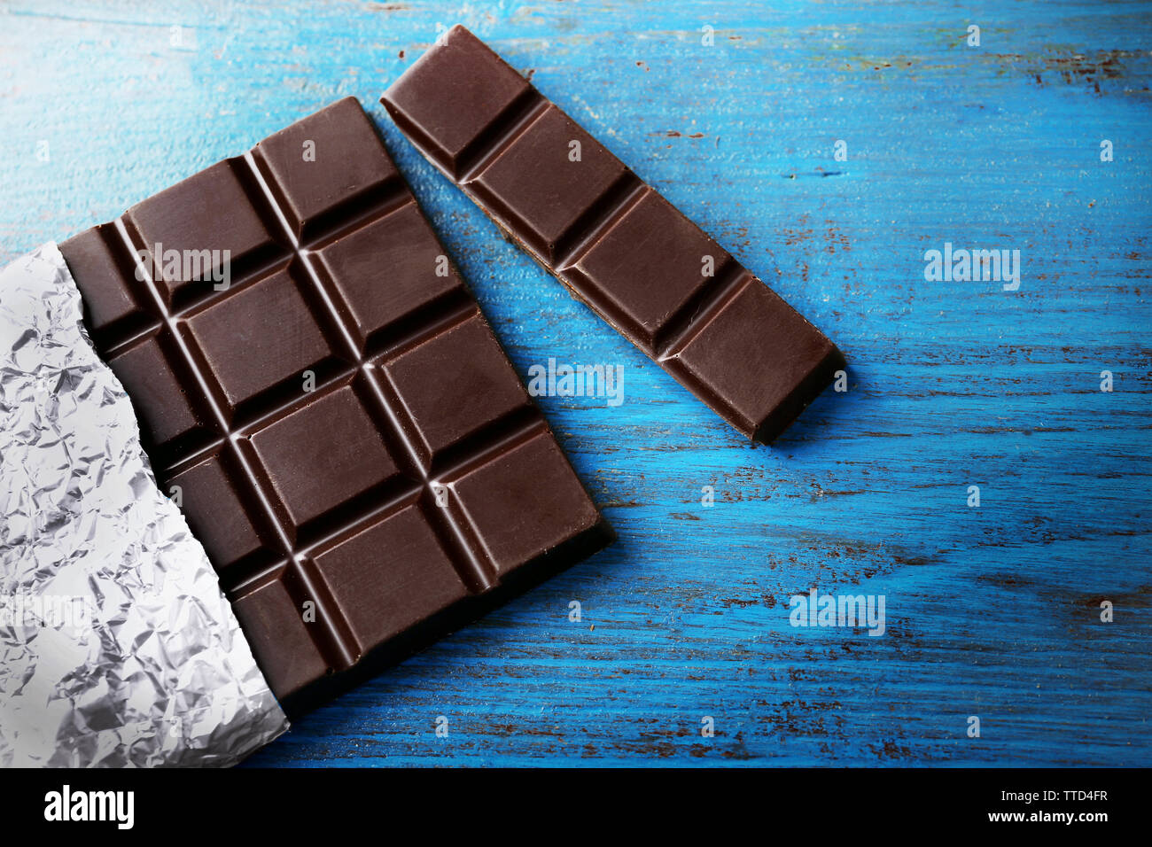 Dark Chocolate bar in foil on gray background Stock Photo - Alamy