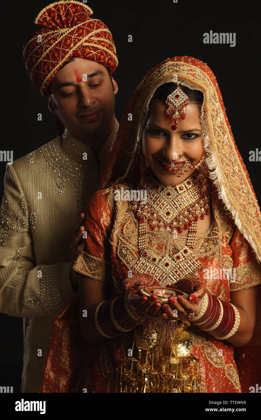 Newlywed couple performing traditional ritual Stock Photo - Alamy