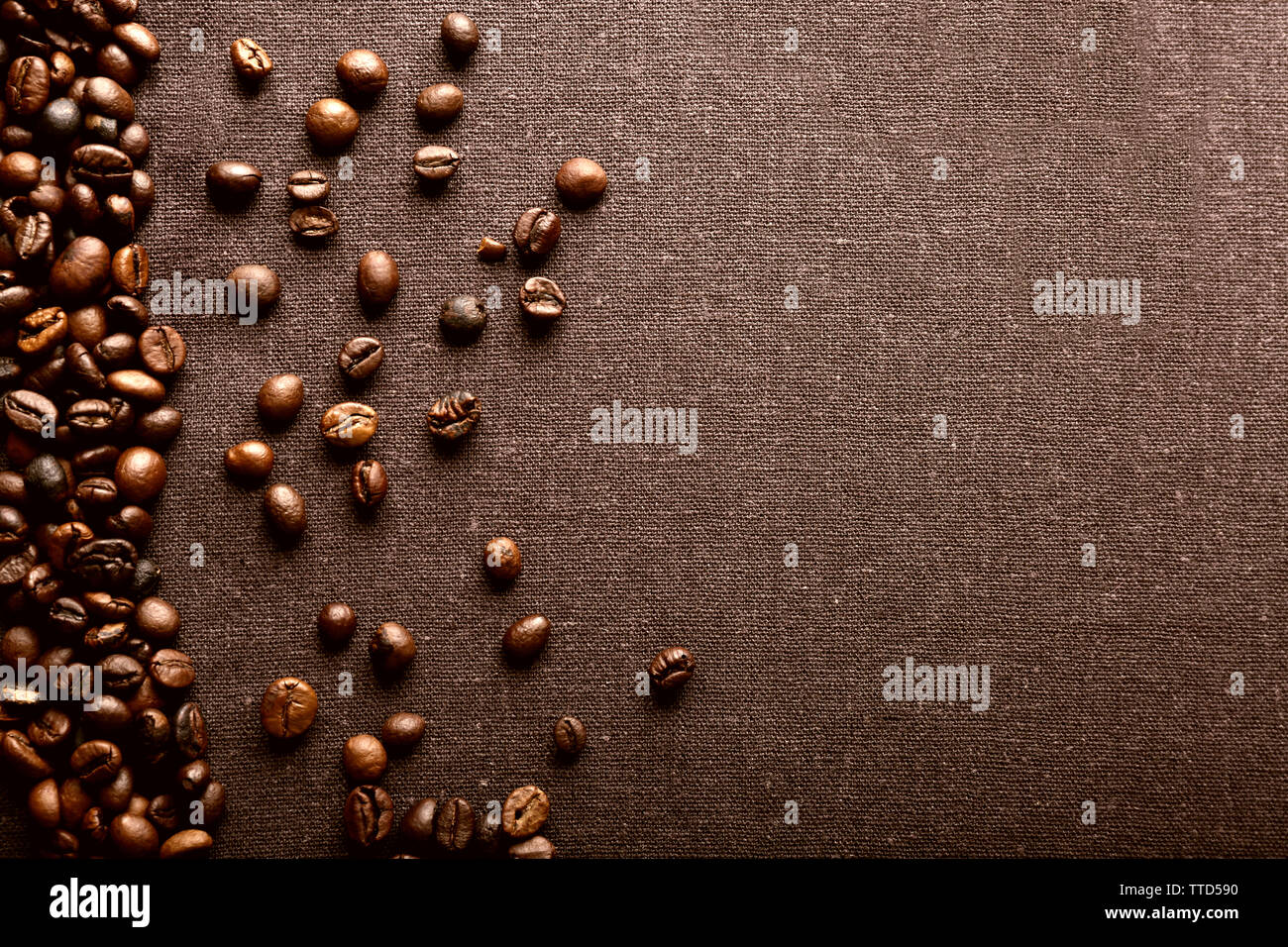 Roasted coffee beans on grey textile background Stock Photo - Alamy