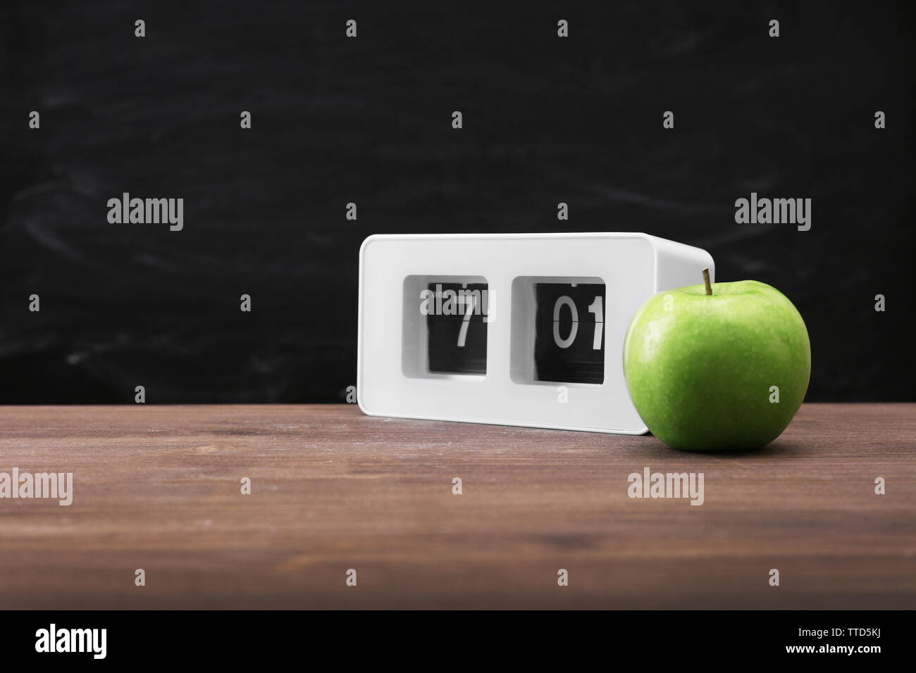 Green apple and clock on blackboard background Stock Photo - Alamy