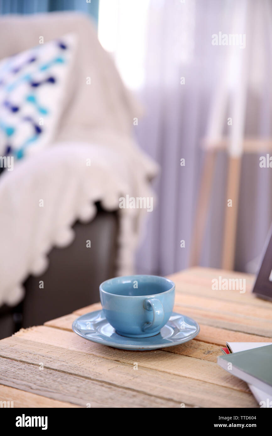 Cup with hot drink on coffee table, on home interior background Stock ...