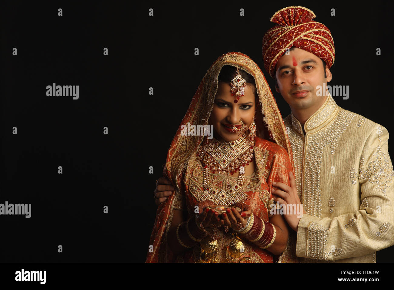 Newlywed couple performing traditional ritual Stock Photo - Alamy