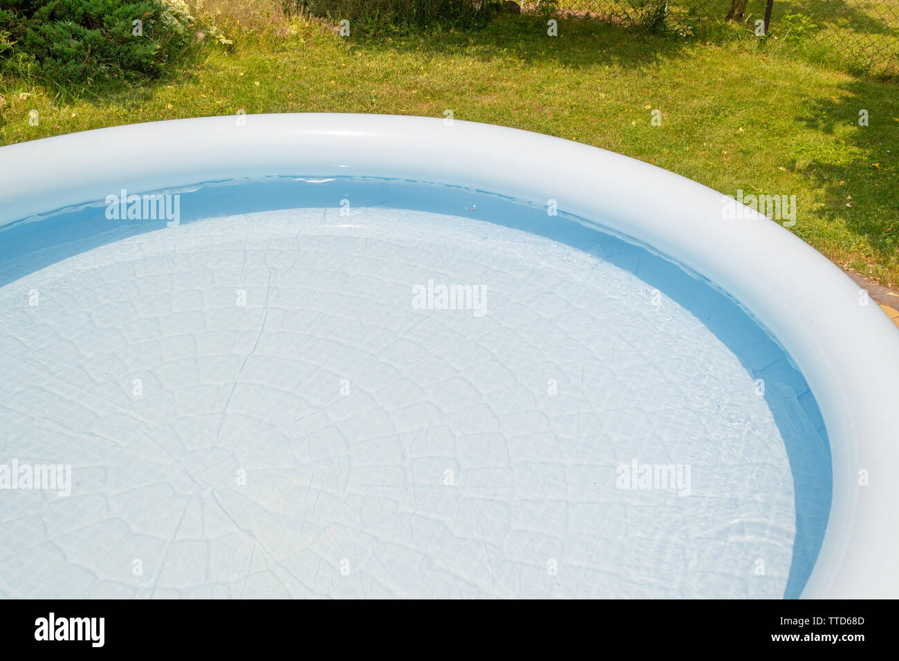 A round, blue, garden pool for children Stock Photo - Alamy