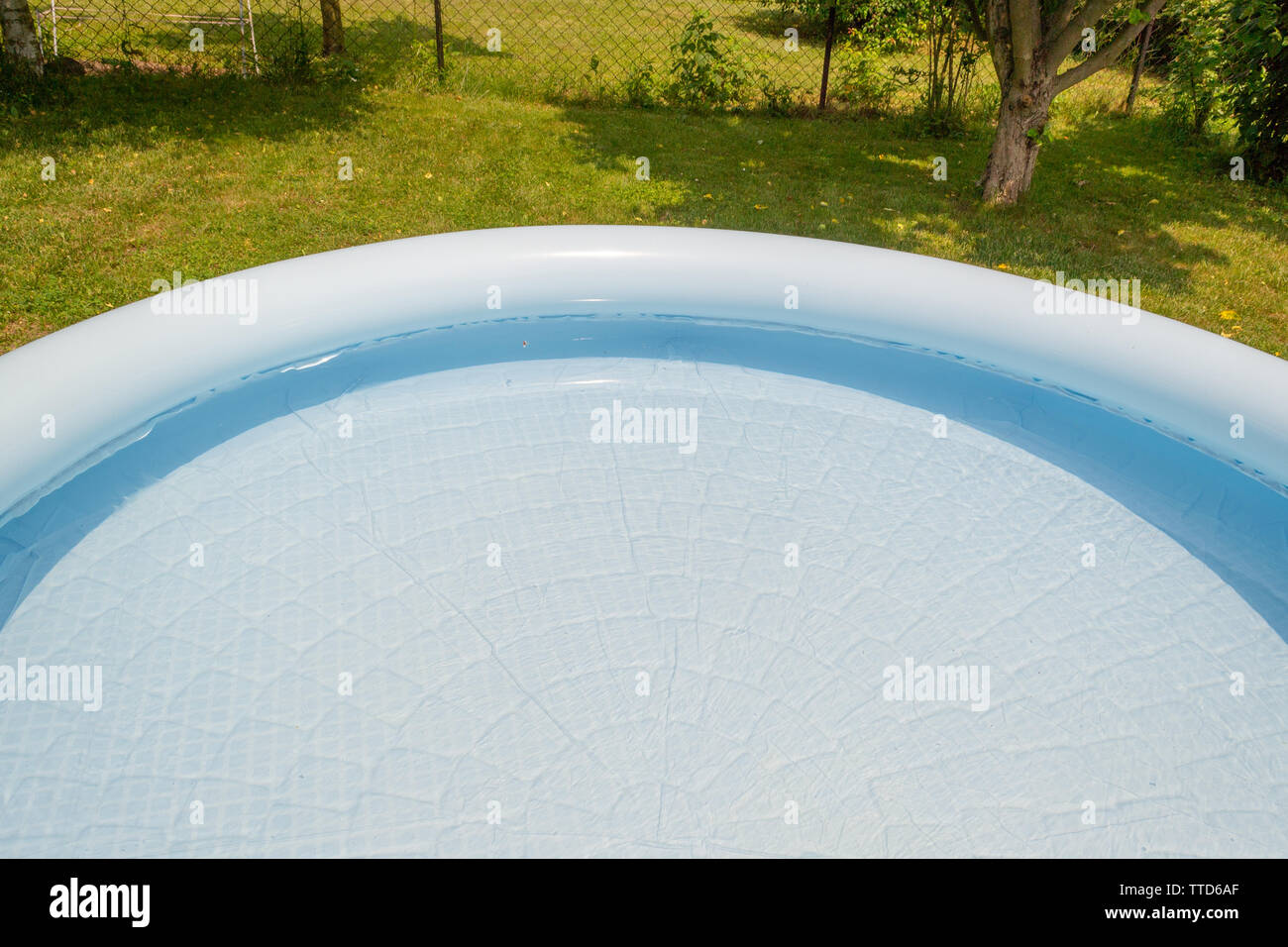 A round, blue, garden pool for children Stock Photo - Alamy