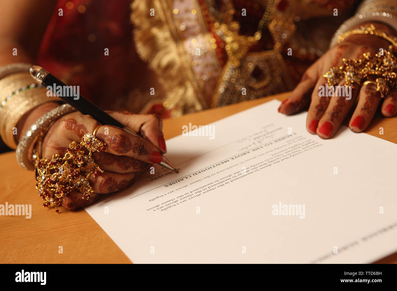 Indian bride signing a marriage certificate Stock Photo - Alamy