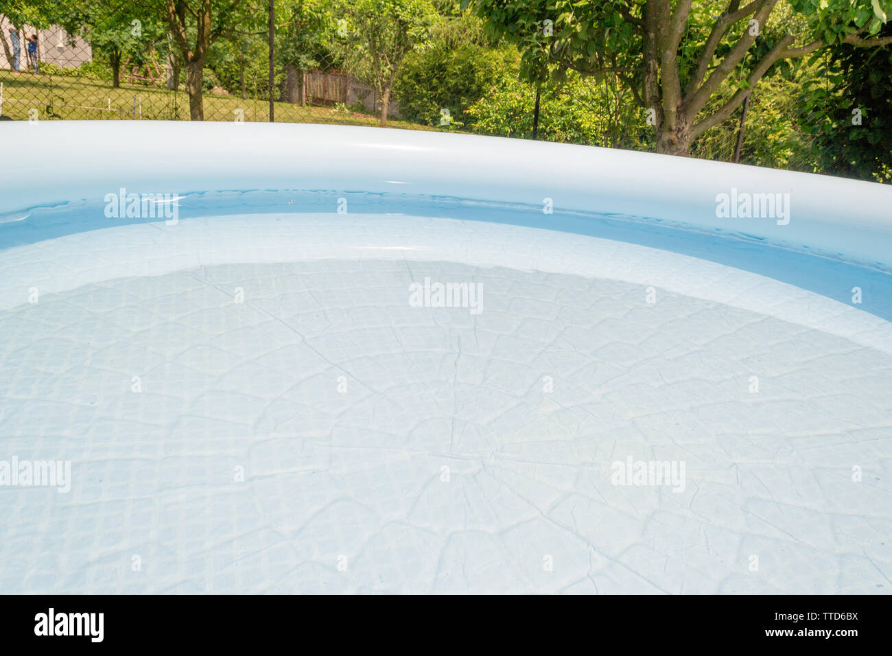 A round, blue, garden pool for children Stock Photo - Alamy