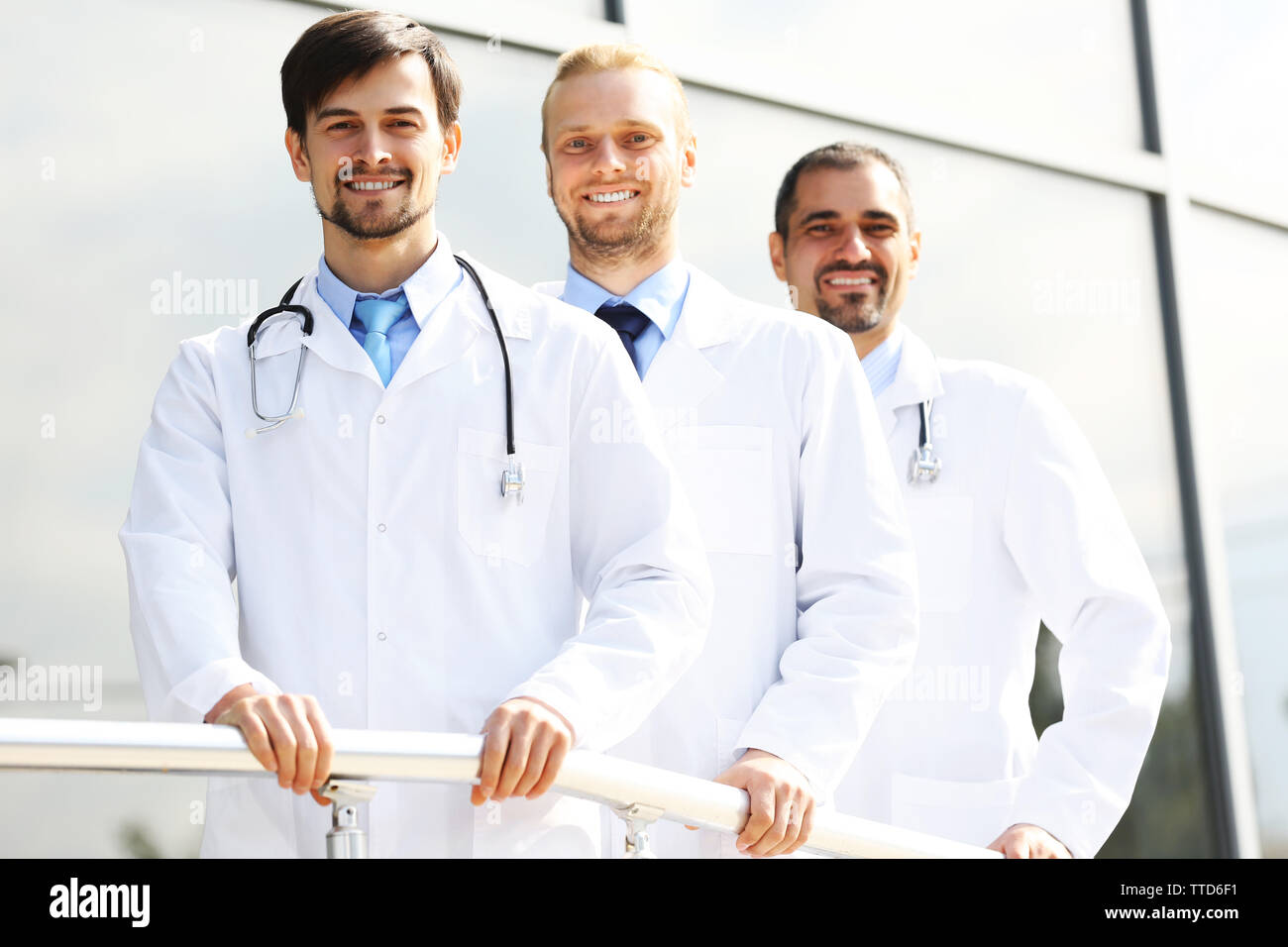 Handsome smiling doctors standing hi-res stock photography and images ...
