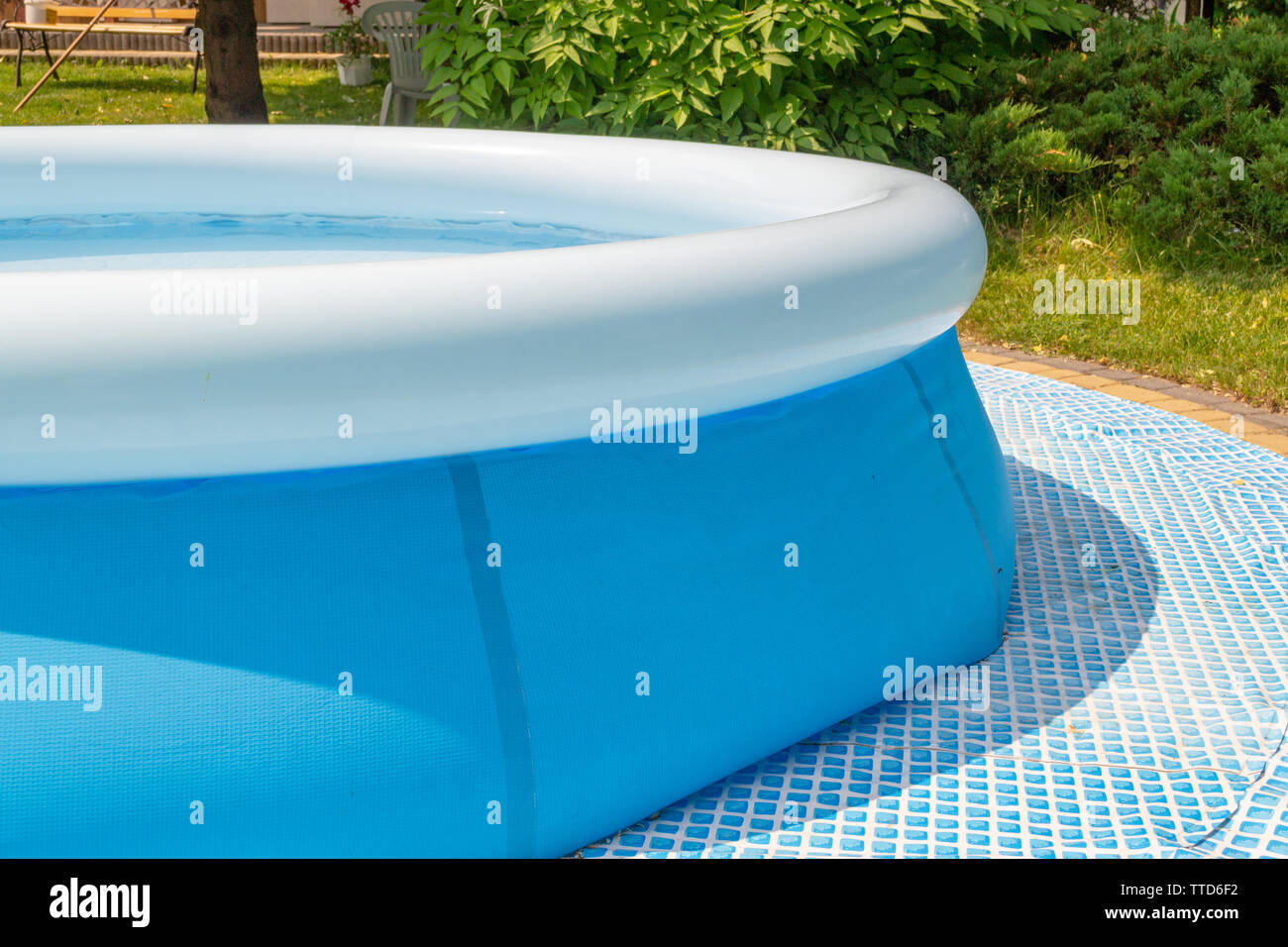 A round, blue, garden pool for children Stock Photo - Alamy