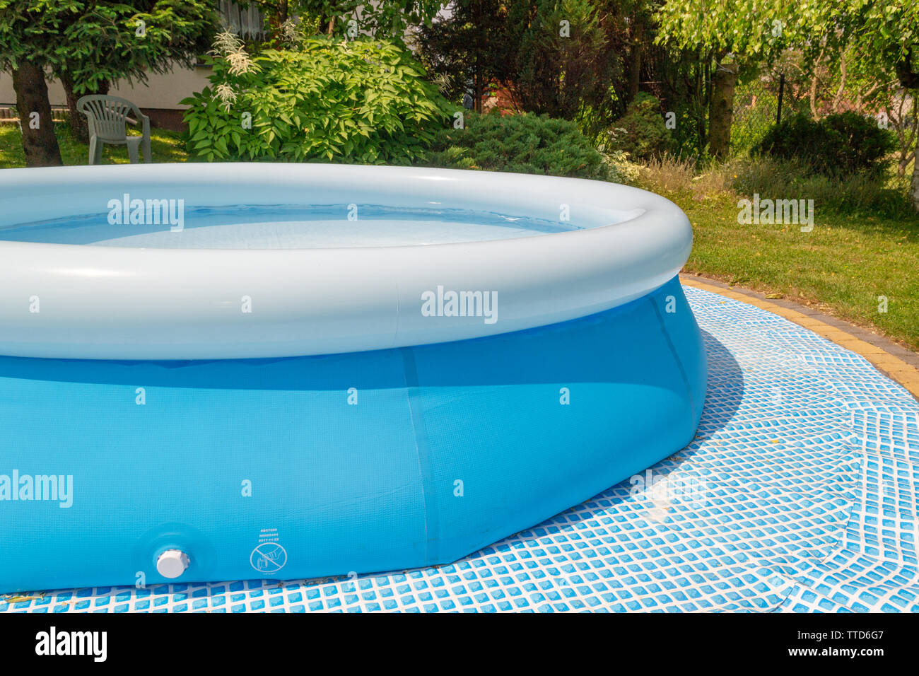A round, blue, garden pool for children Stock Photo - Alamy