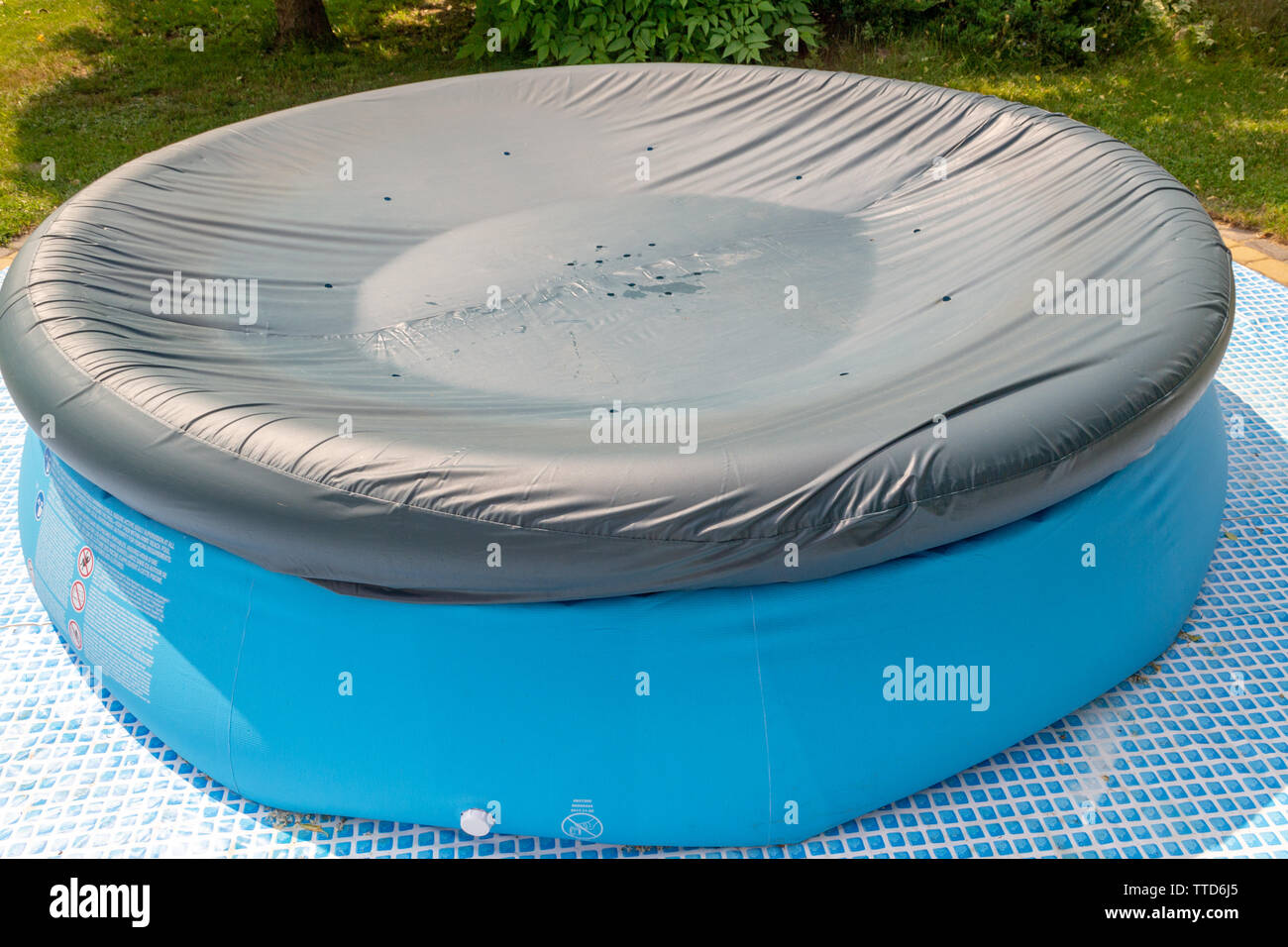 A round, blue, garden pool for children Stock Photo - Alamy