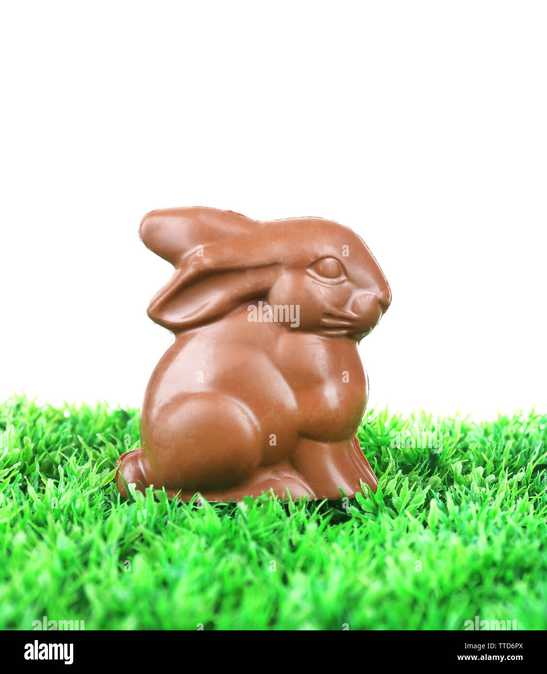 Chocolate Easter bunny on green grass, on white background Stock Photo ...